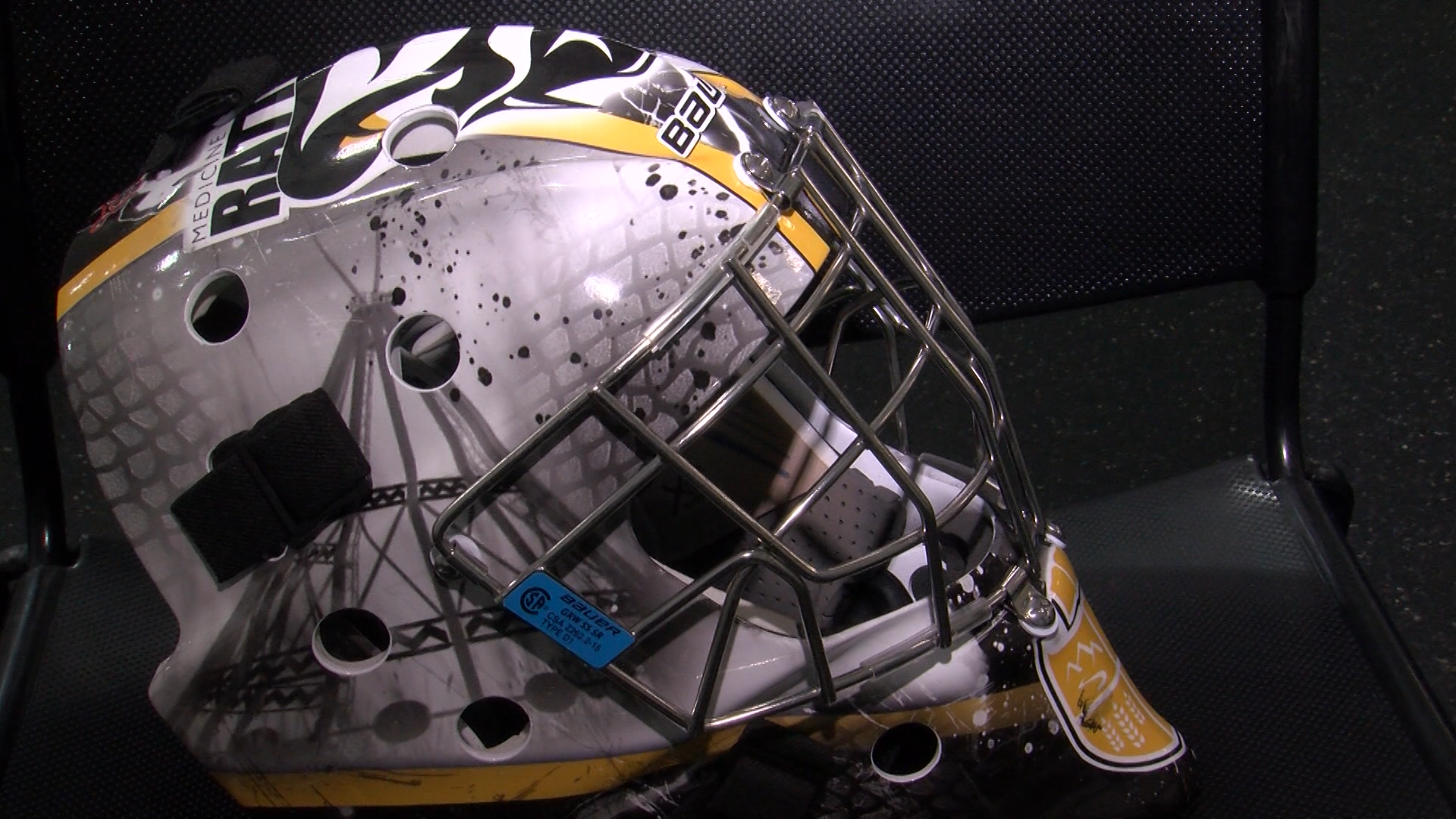 New Rattlers goaltender, suited with teepee-wrapped helmet, embracing ...